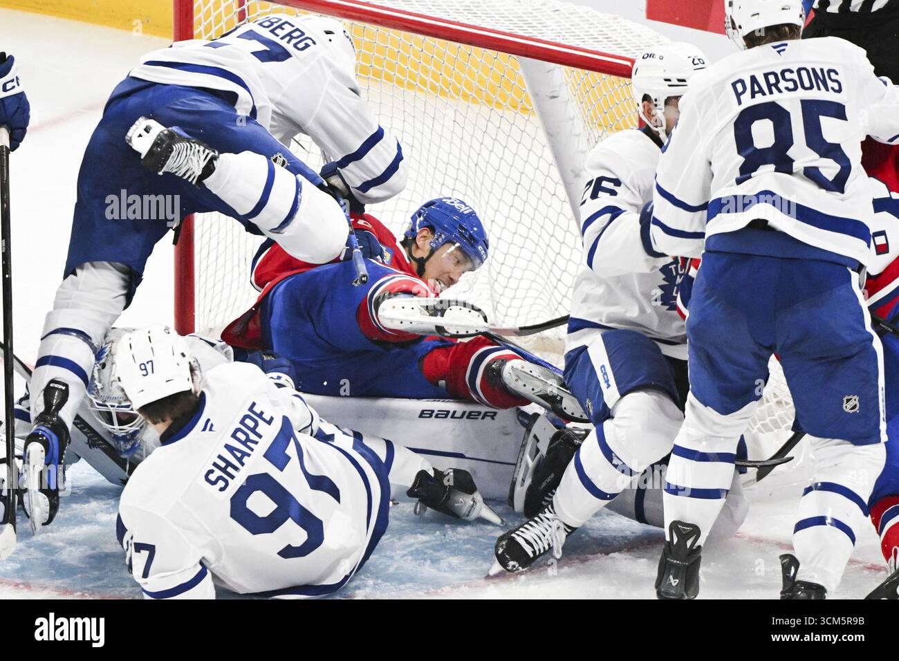 Montreal Canadiens' Matthew Wang, center, is pushed into the Toronto ...