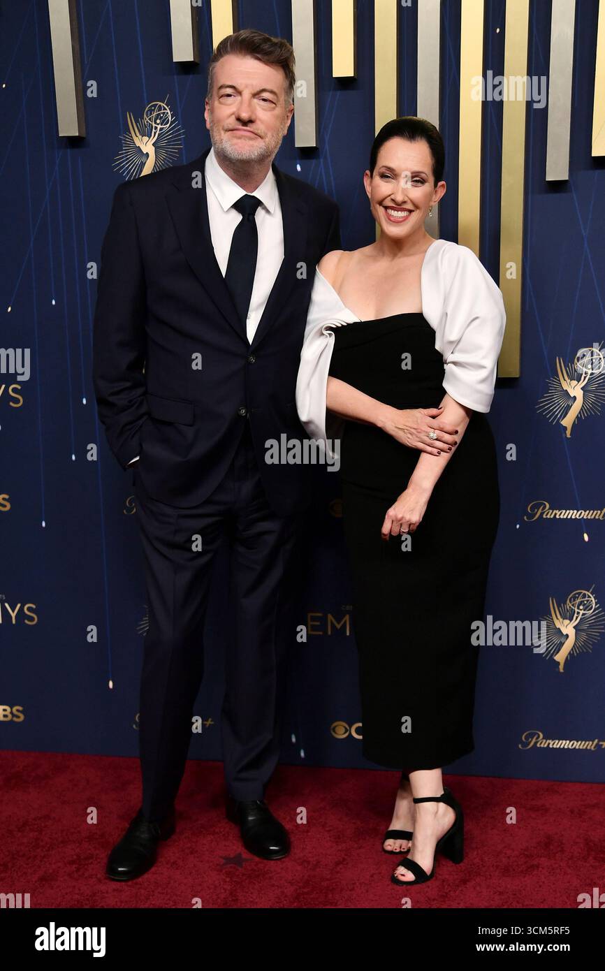 Charlie Brooker, left, and Jessica Rhoades arrive at the 77th Primetime ...