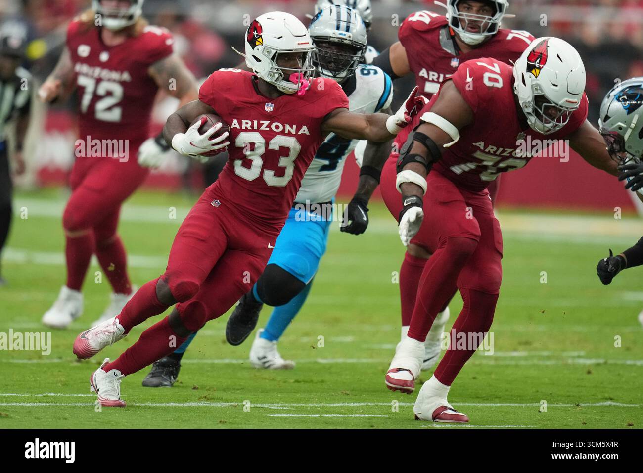 Arizona Cardinals running back Trey Benson (33) runs against the ...