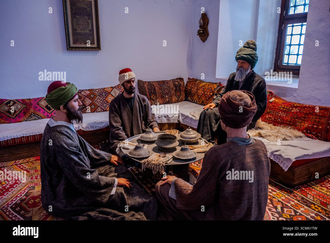 Lifelike wax figures depict dervishes in traditional attire gathered ...