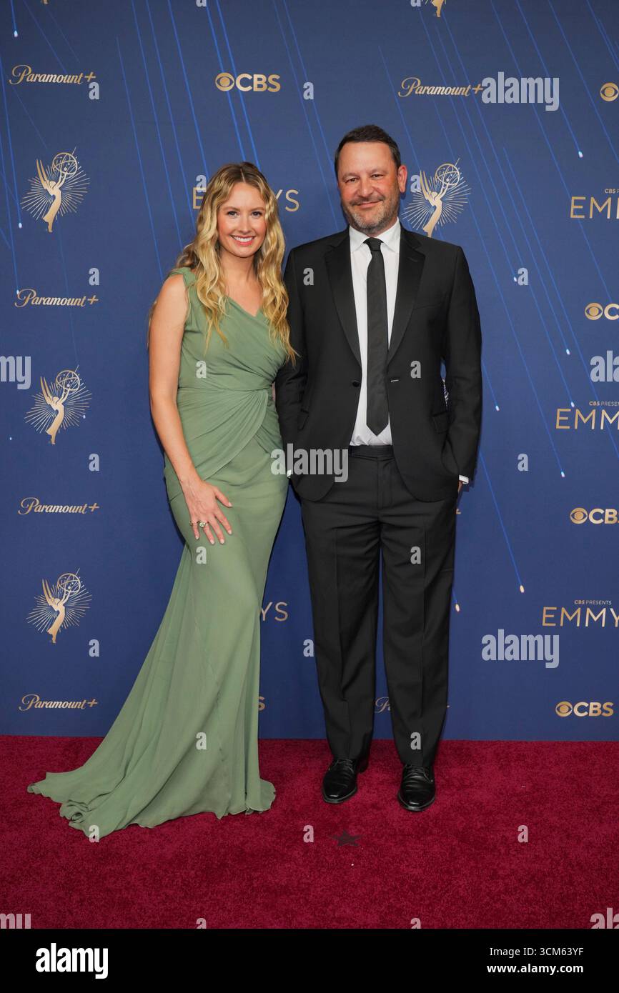 Caitlin Thompson, left, and Dan Fogelman arrive at the 77th Emmy Awards ...