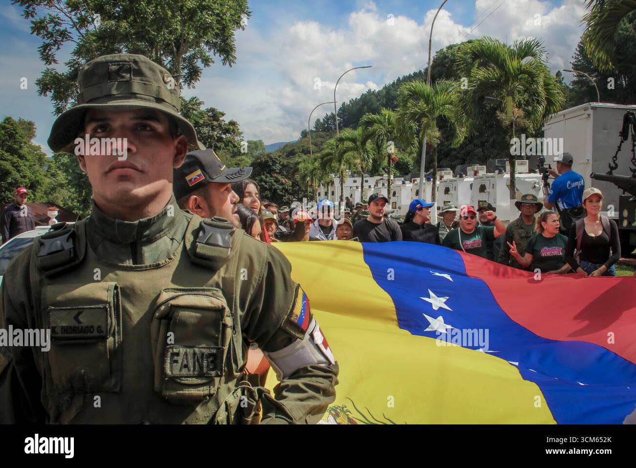 Several civilians and soldiers holding a flag perform formations during ...