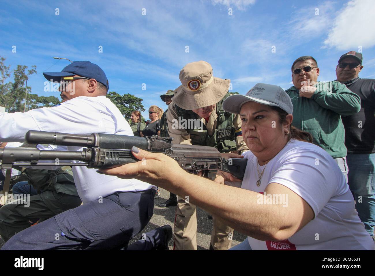 San Cristobal, Venezuela. 13th Sep, 2025. A civilian aims his assault ...