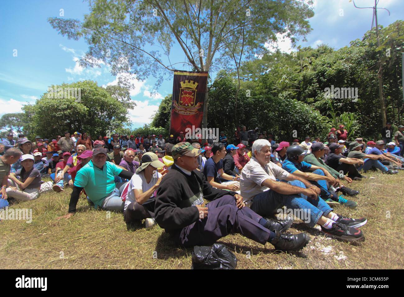 A group of civilians gather outside a military training barracks in the ...
