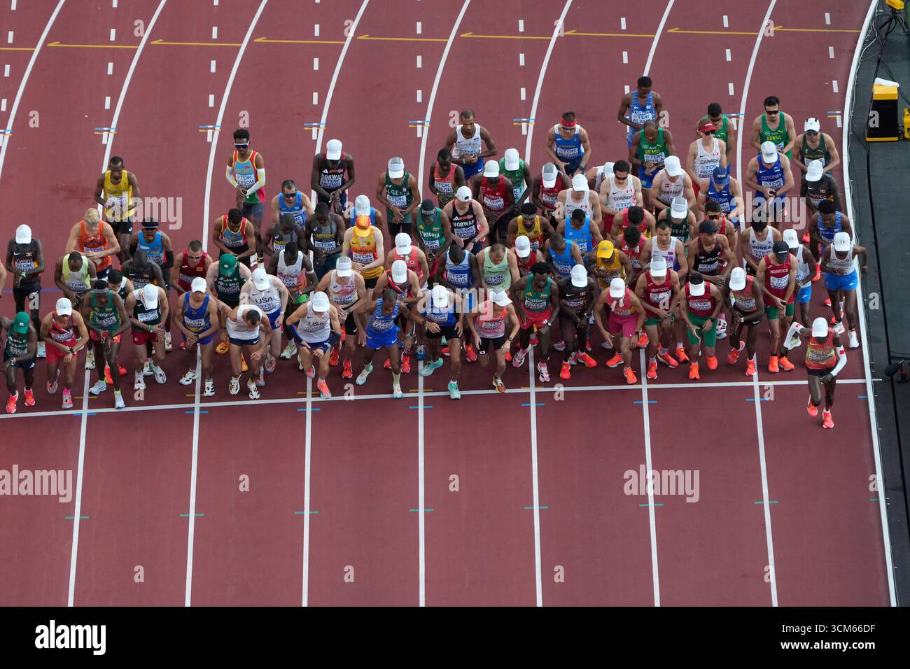Kenya's Vincent Kipkemoi Ngetich, right, makes a false start in the men ...