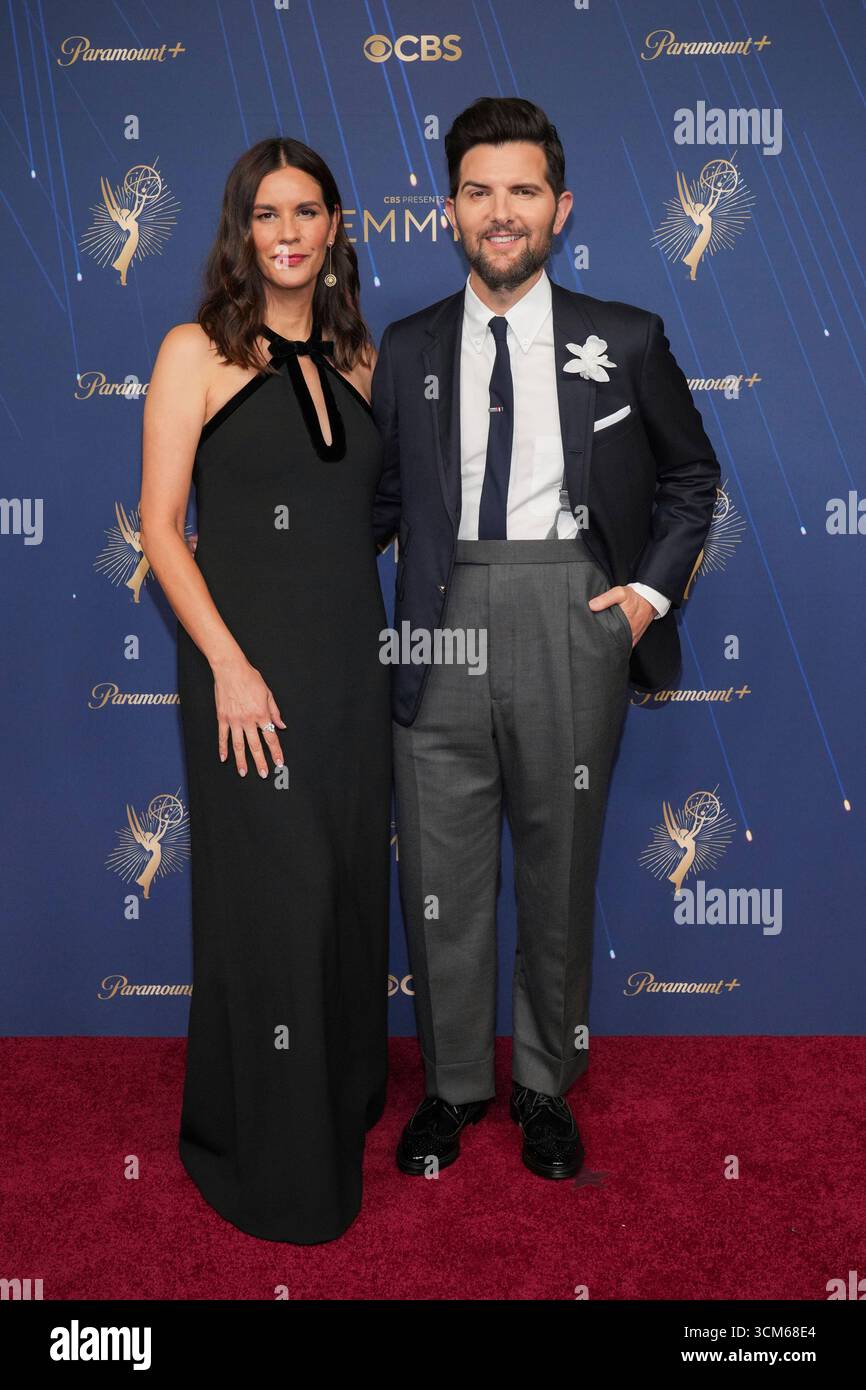 Naomi Scott, left, and Adam Scott arrive at the 77th Emmy Awards on Sunday, Sept. 14, 2025 at ...