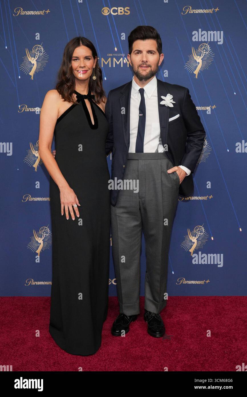 Naomi Scott, left, and Adam Scott arrive at the 77th Emmy Awards on Sunday, Sept. 14, 2025 at ...