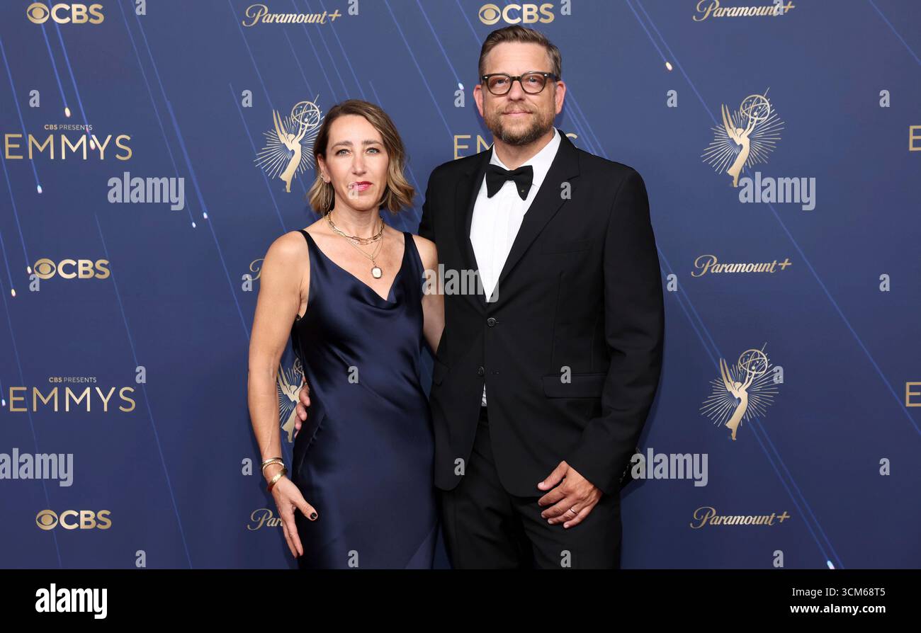 Erin Zimring, left, and Daniel Pipski arrive at the 77th Emmy Awards on ...