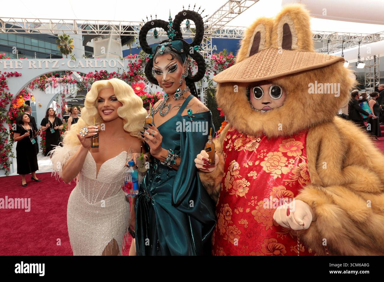 Sam Star, from left, Arrietty and Joella walk the red carpet at the 77th Emmy Awards on Sunday ...