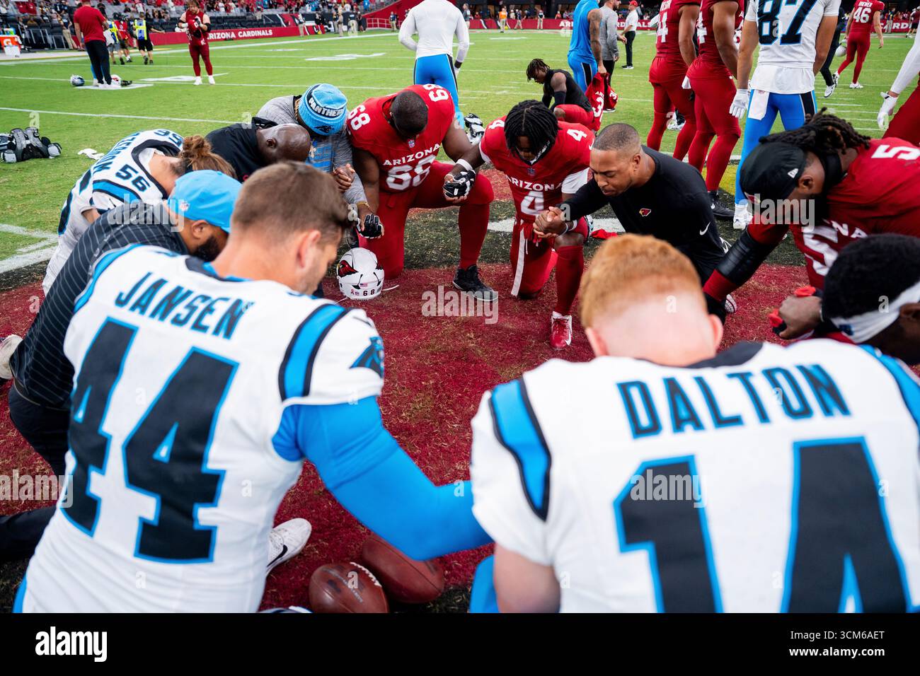 Arizona Cardinals and Carolina Panthers players pray after a NFL ...