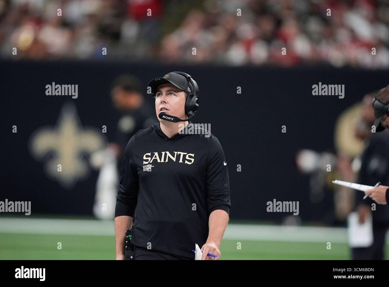 New Orleans Saints head coach Kellen Moore walks on the sideline in the ...