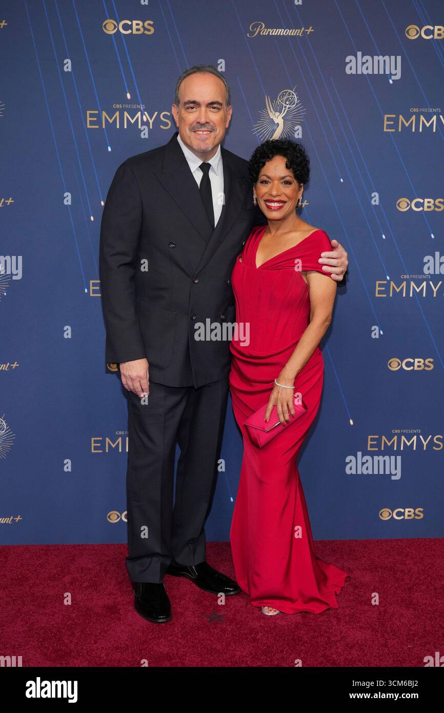 David Zayas, left, and Liza Colón-Zayas arrive at the 77th Emmy Awards ...