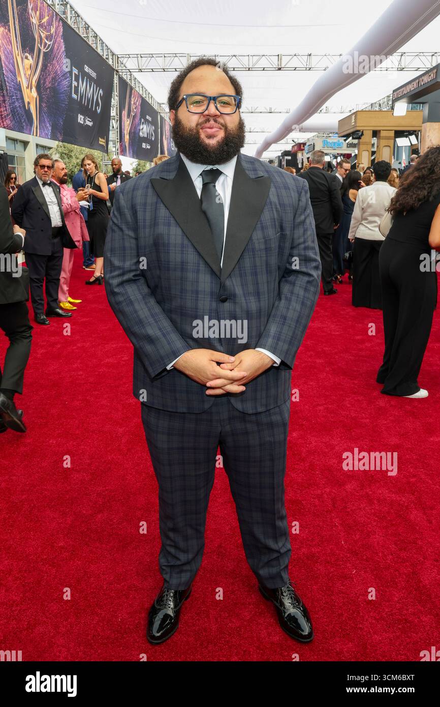 Zach Cherry walks the red carpet at the 77th Emmy Awards on Sunday ...