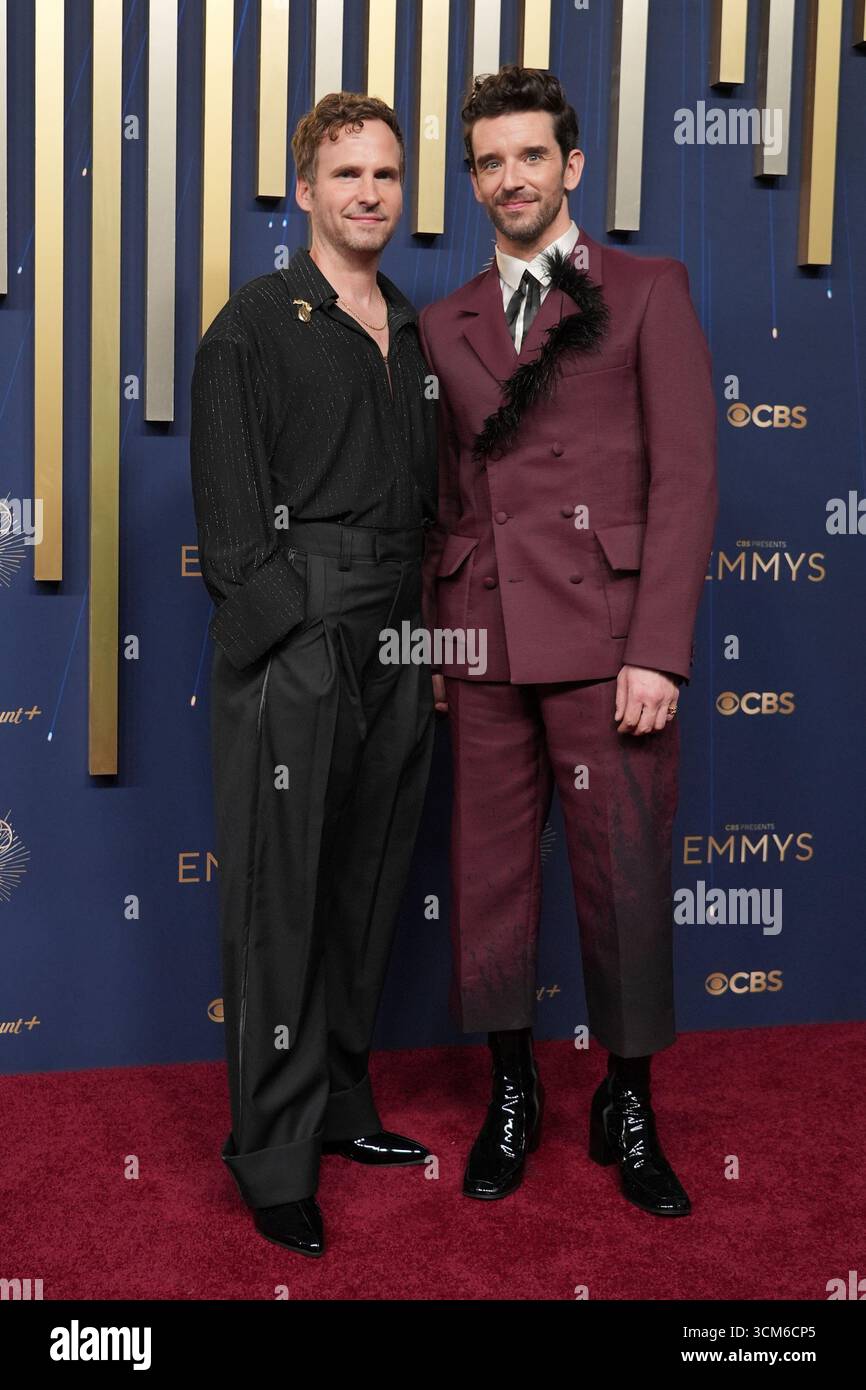Ryan Spahn, left, and Michael Urie arrive at the 77th Primetime Emmy Awards on Sunday, Sept. 14 ...