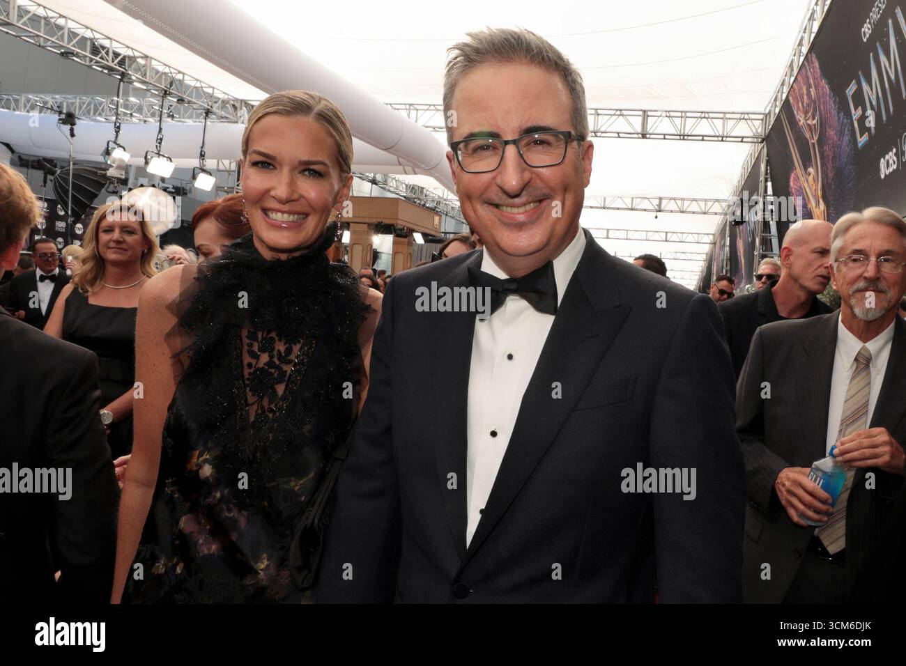 kate-norley-left-and-john-oliver-walk-the-red-carpet-at-the-77th-emmy