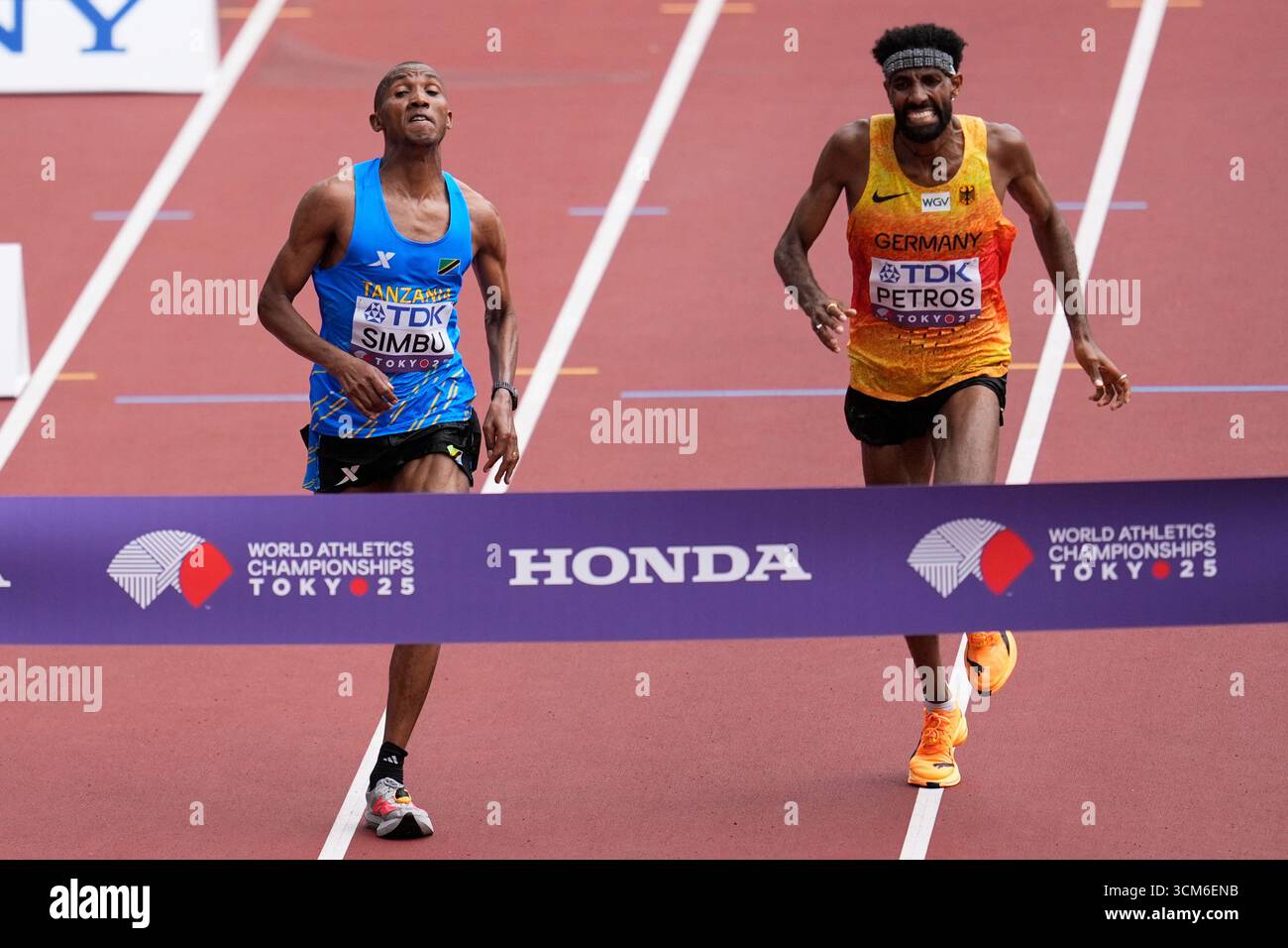 Germany's Amanal Petros and Tanzania's Alphonce Felix Simbu, left, race ...