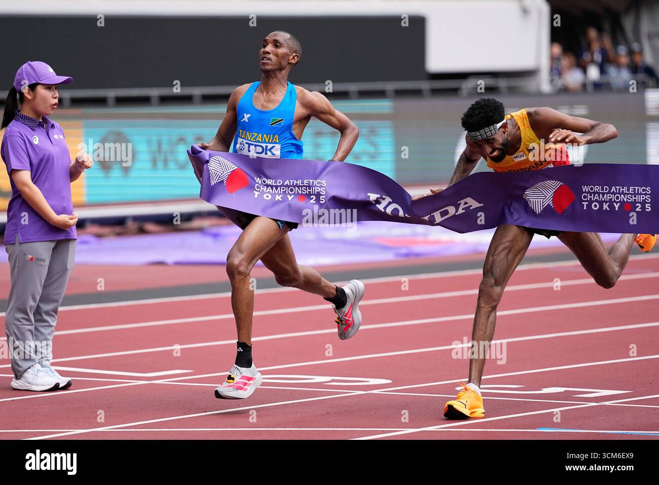 Tanzania's Alphonce Felix Simbu, left, crosses the finish line to win ...