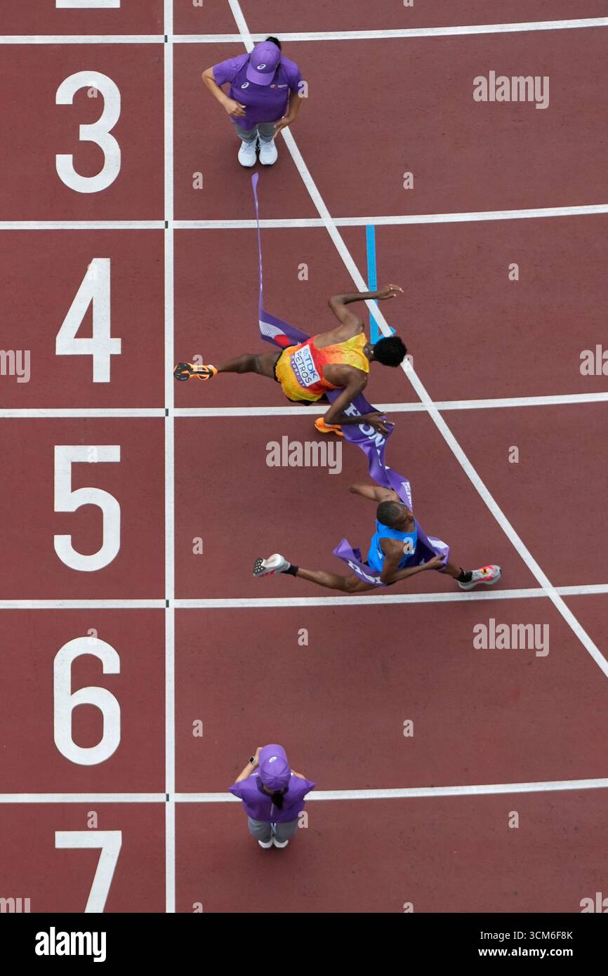 Tanzania's Alphonce Felix Simbu, bottom, crosses the finish line ahead ...