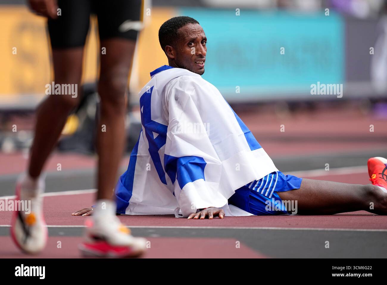 Israel's Haimro Alame sits on the track after the men's marathon at the ...
