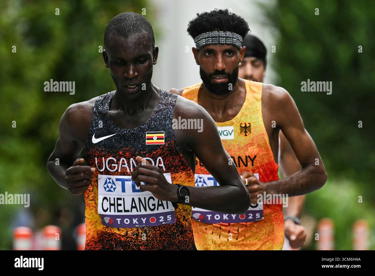 Uganda's Abel Chelangat, front, and Germany's Amanal Petros compete in ...
