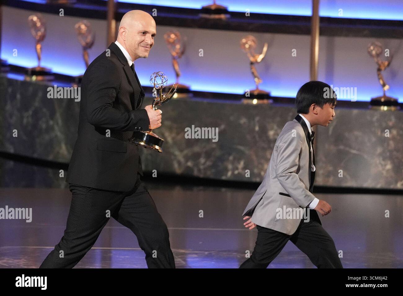 Adam Randall, left, winner of the award for outstanding directing for a drama series for "Slow ...