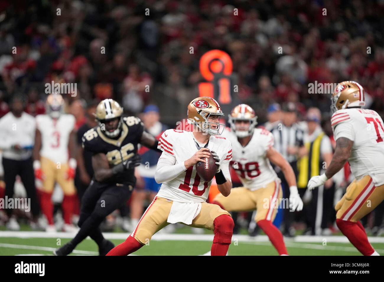 San Francisco 49ers quarterback Mac Jones (10) drops back to pass in ...