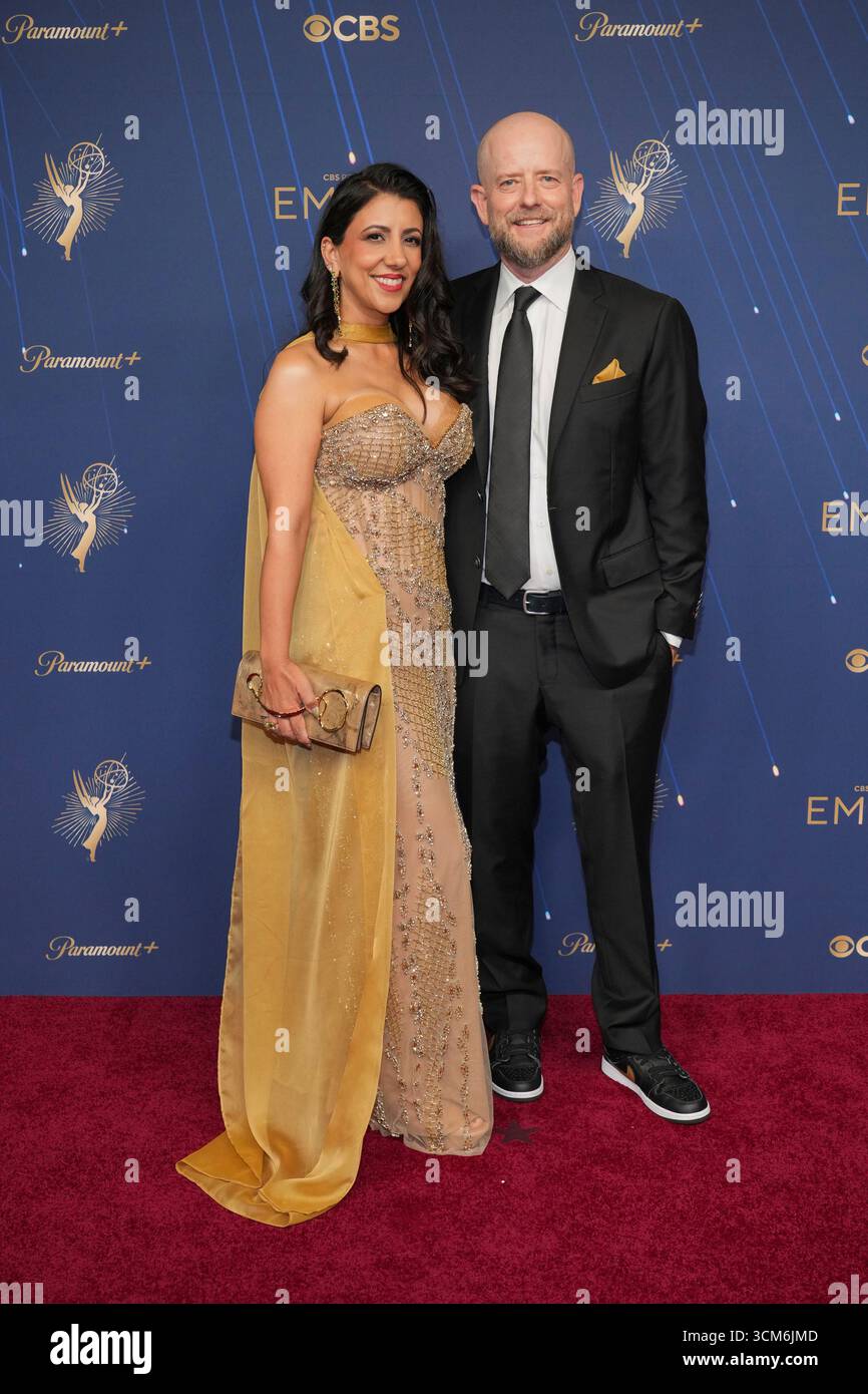 Brian Rubenstein, right, arrives at the 77th Emmy Awards on Sunday ...