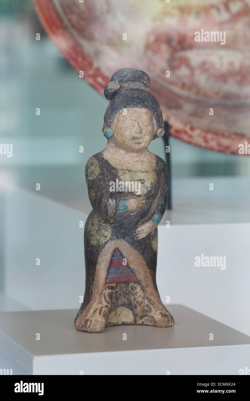 Close up to an antique mayan figure of a woman of high class with ...