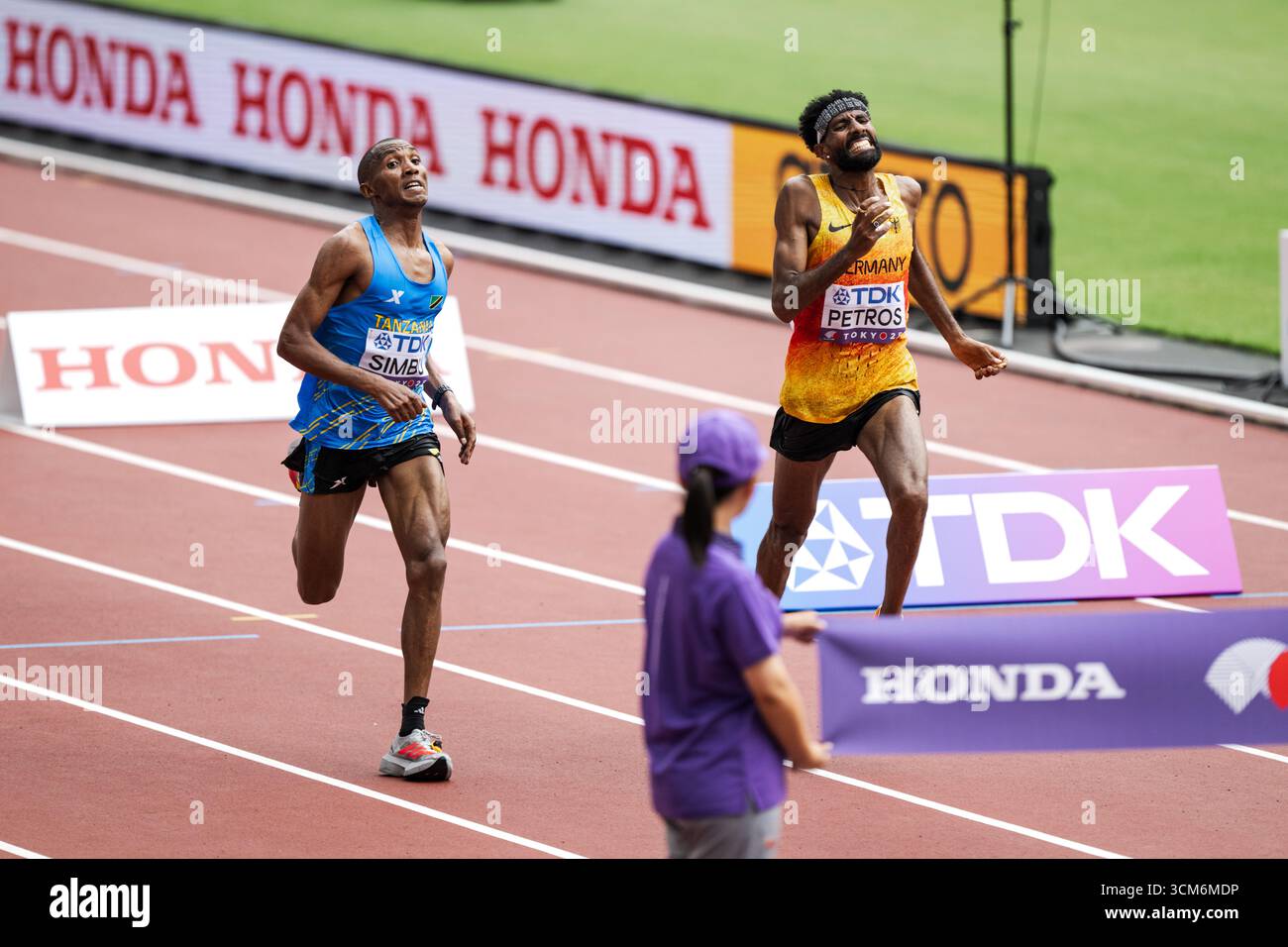 Alphonce Felix Simbu of Tanzania (Left) races Amanal Petros of Germany ...