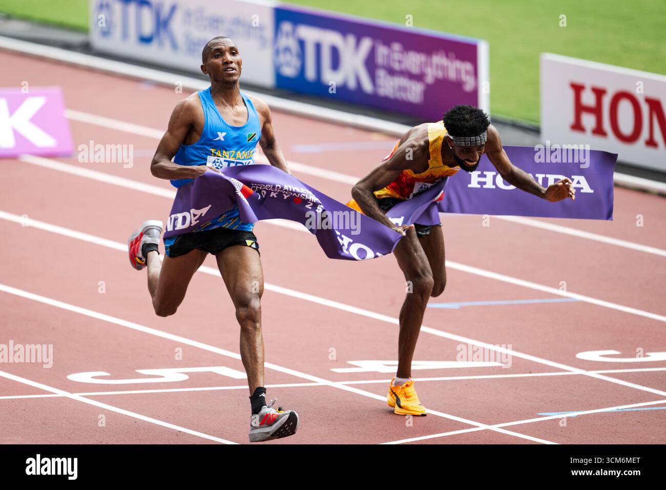 Alphonce Felix Simbu of Tanzania (Left) races Amanal Petros of Germany ...