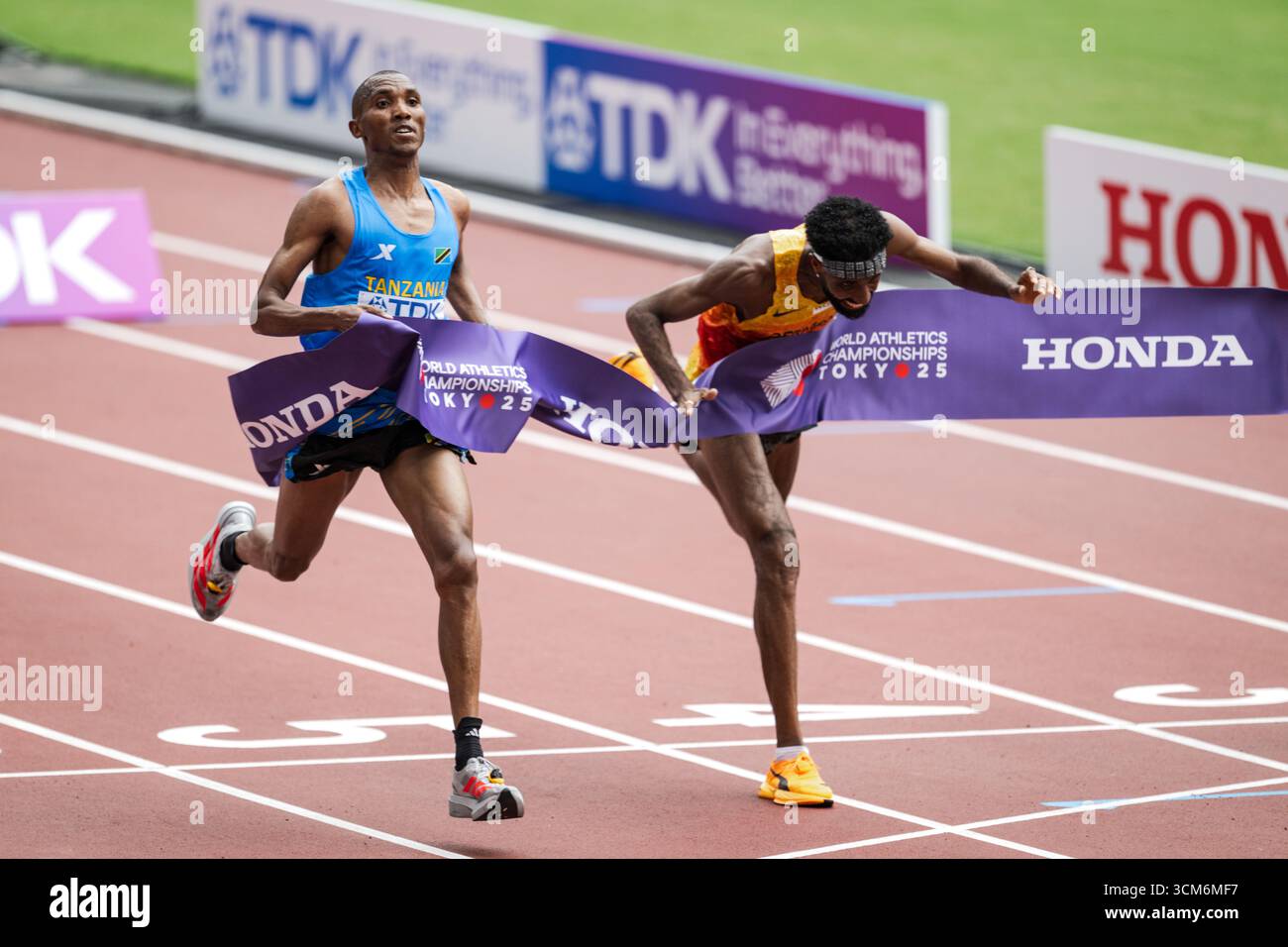 Alphonce Felix Simbu of Tanzania (Left) races Amanal Petros of Germany ...