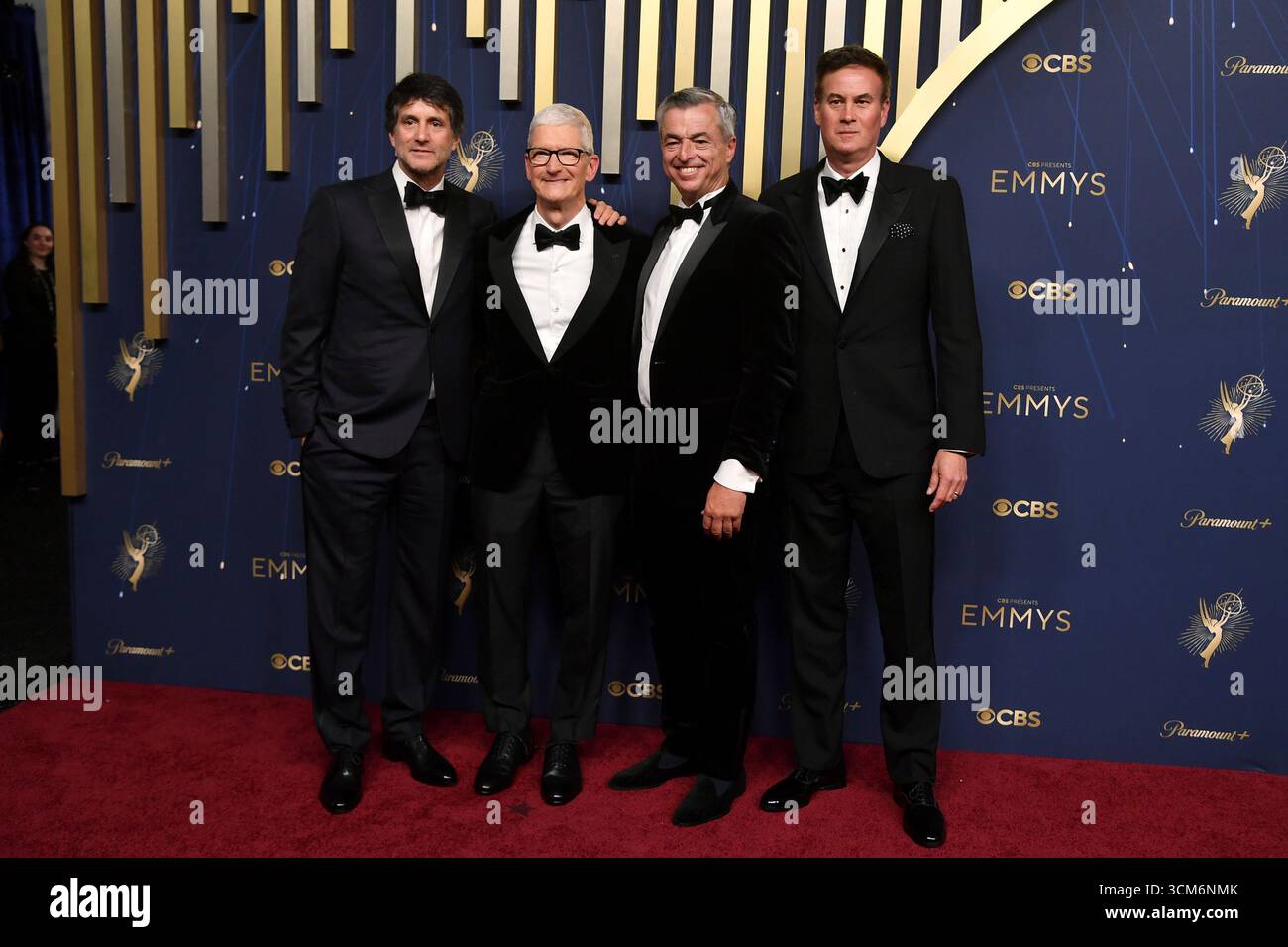 Jamie Erlicht, from left, Tim Cook, Eddy Cue and Zack Van Amburg arrive ...