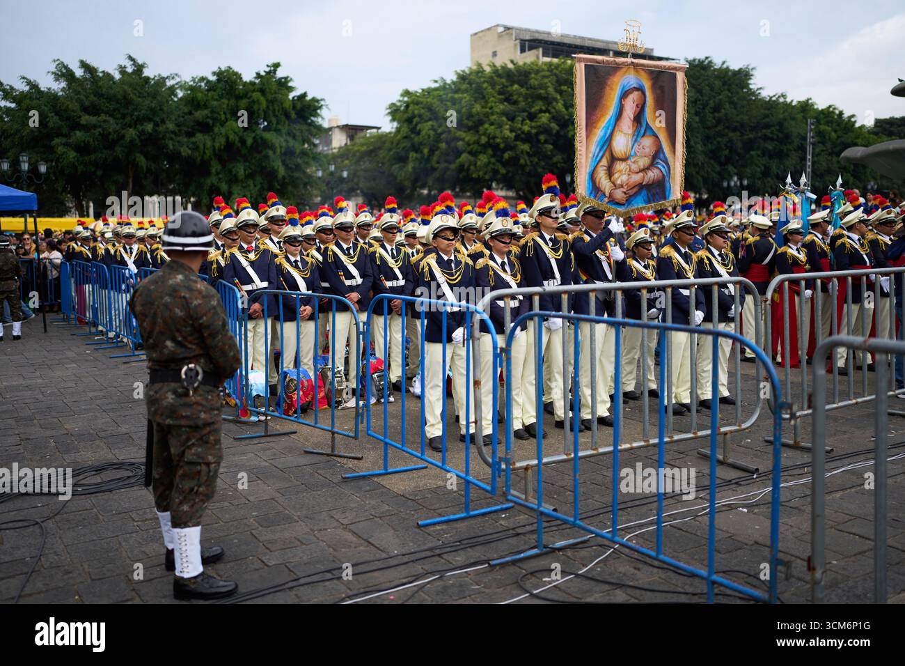 Members of a marching band hold a religious image of the Virgin Mary as ...