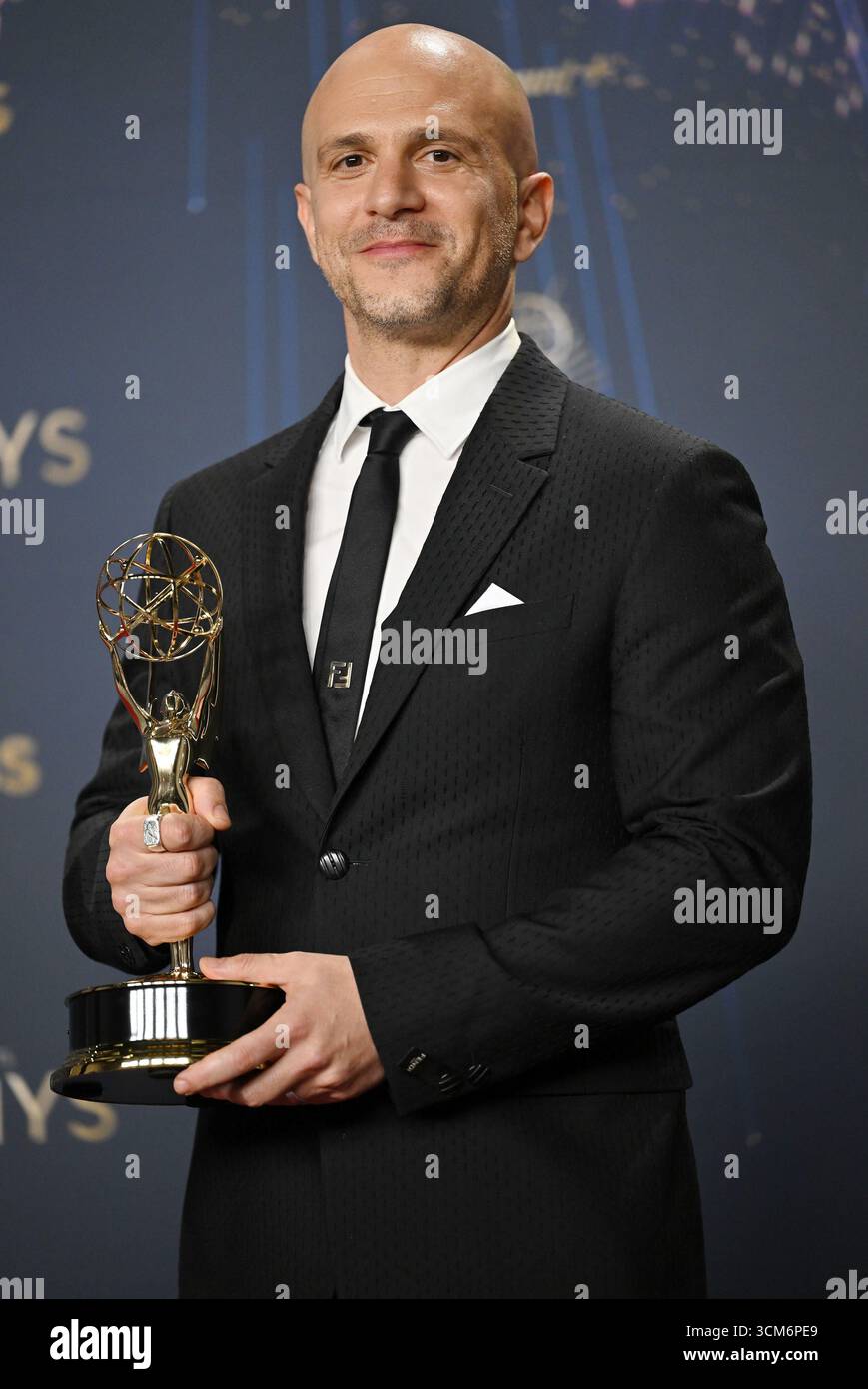 Adam Randall holds the Emmy for Outstanding Directing for a Drama ...