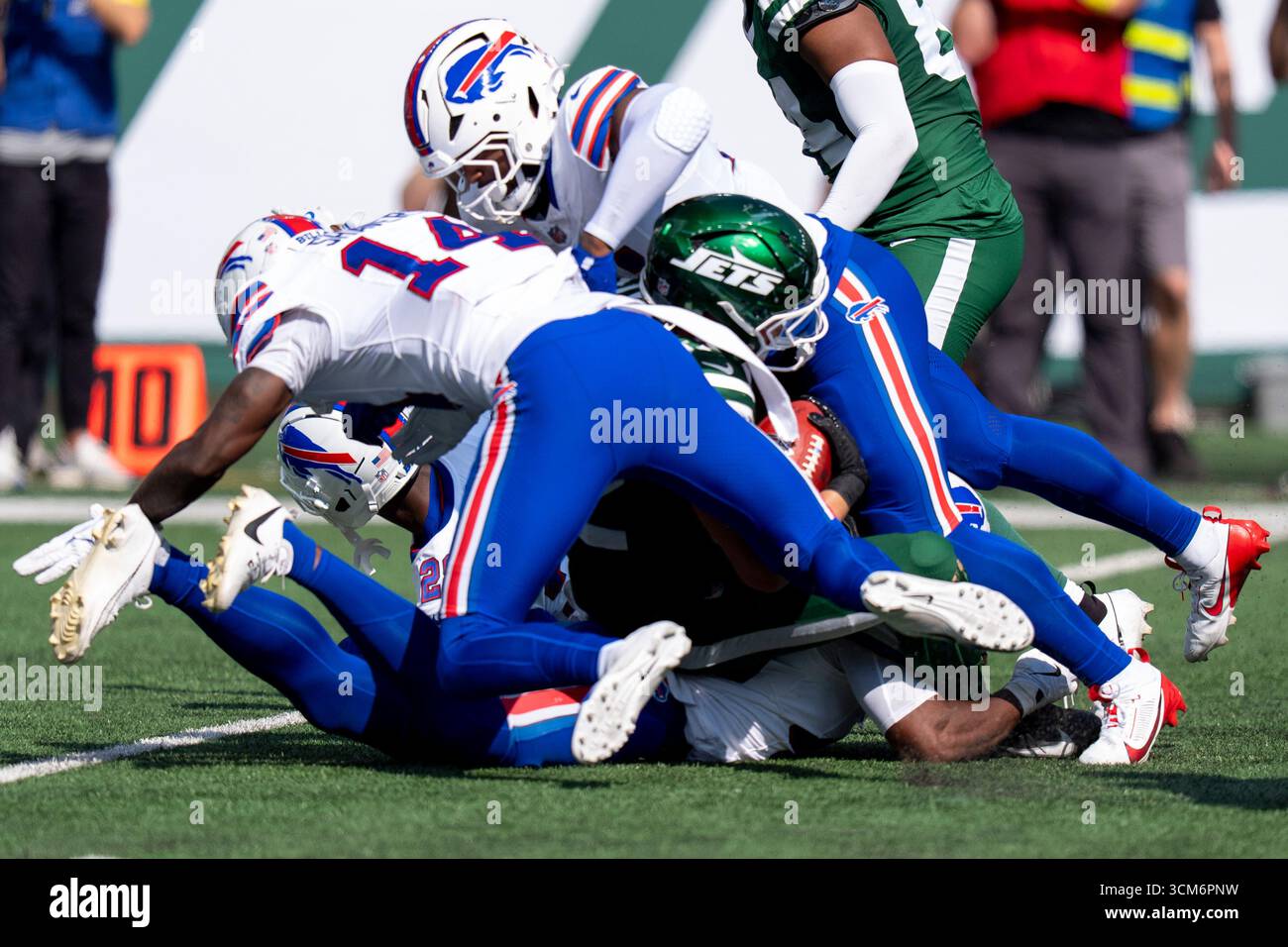 New York Jets running back Isaiah Davis (32) gets gang tackled by the ...
