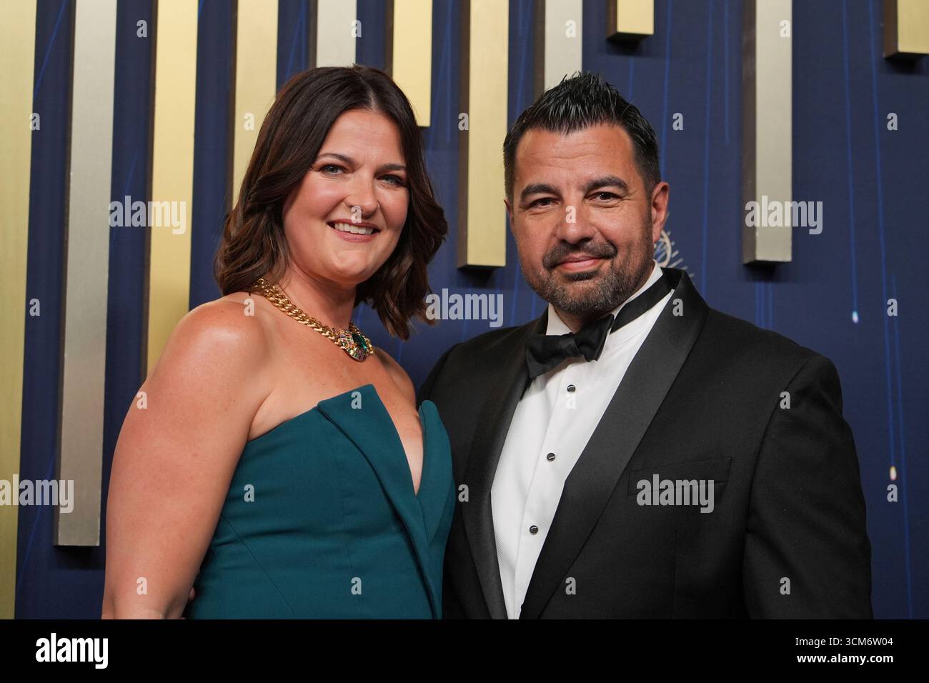 David Meanti, right, arrives at the 77th Primetime Emmy Awards on ...