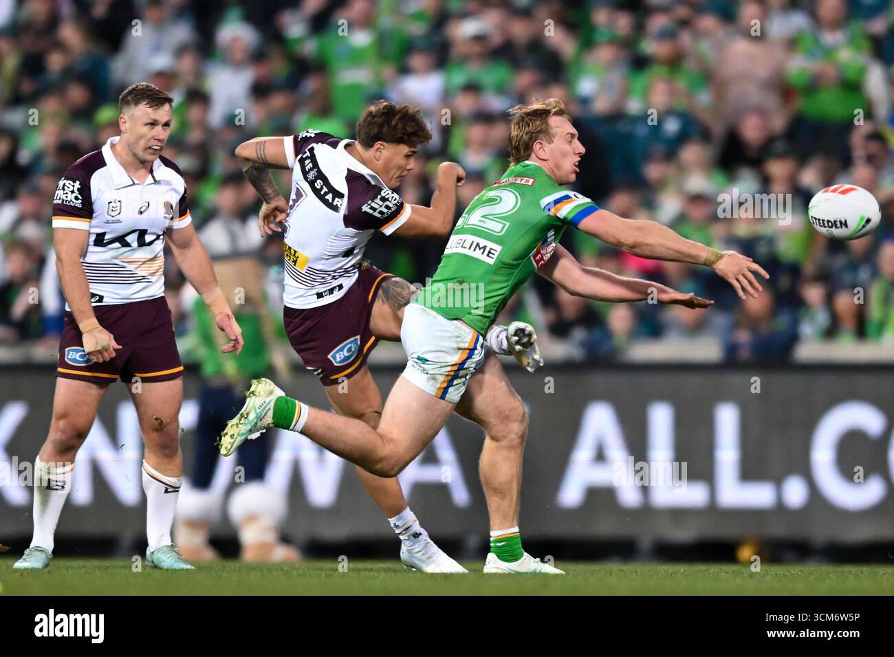 Zac Hosking of the Raiders tries to intercept a kick by Reece Walsh of ...
