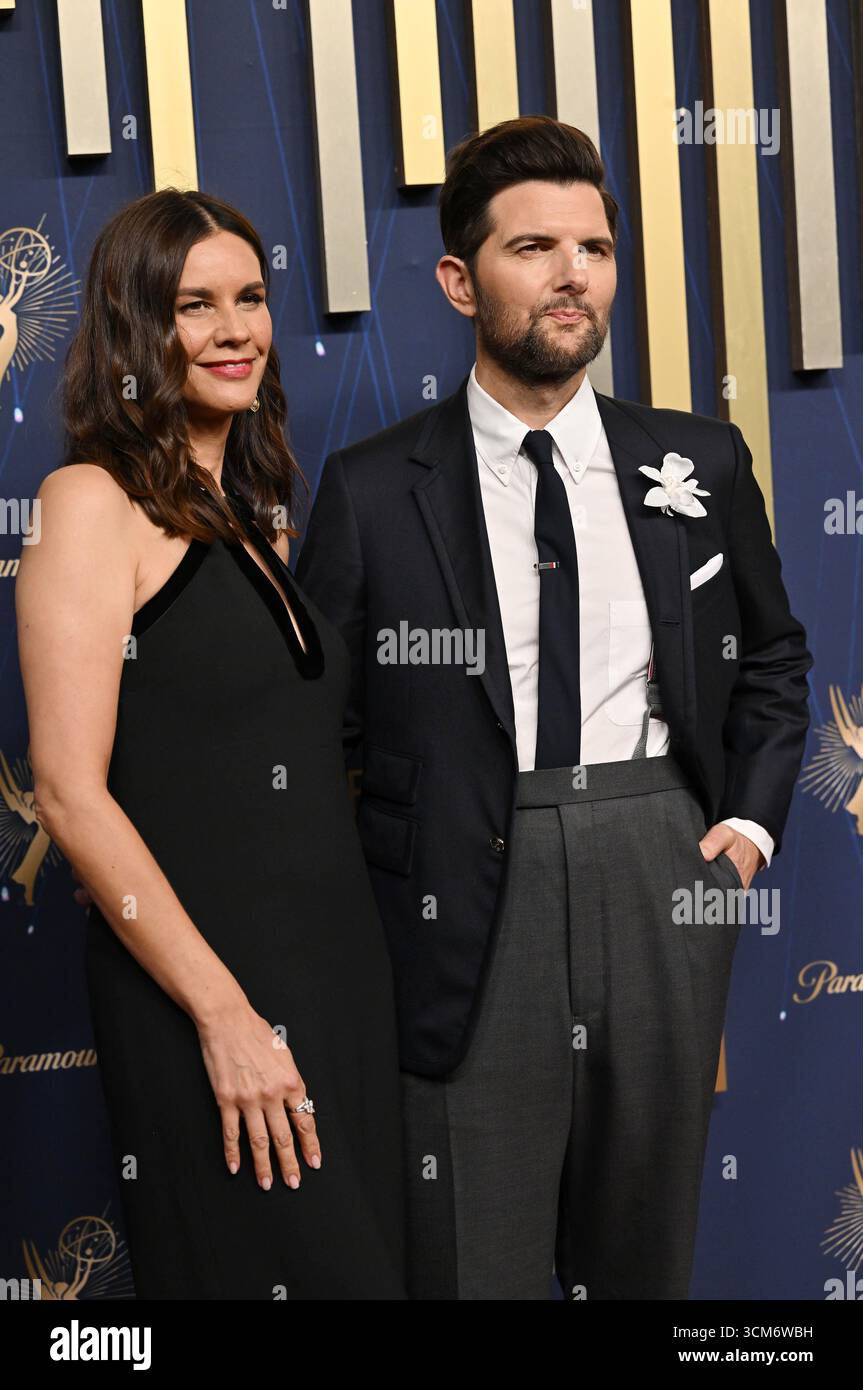 (L-R) Naomi Scott and Adam Scott arrive for the 77th annual Primetime Emmy Awards at the Peacock ...
