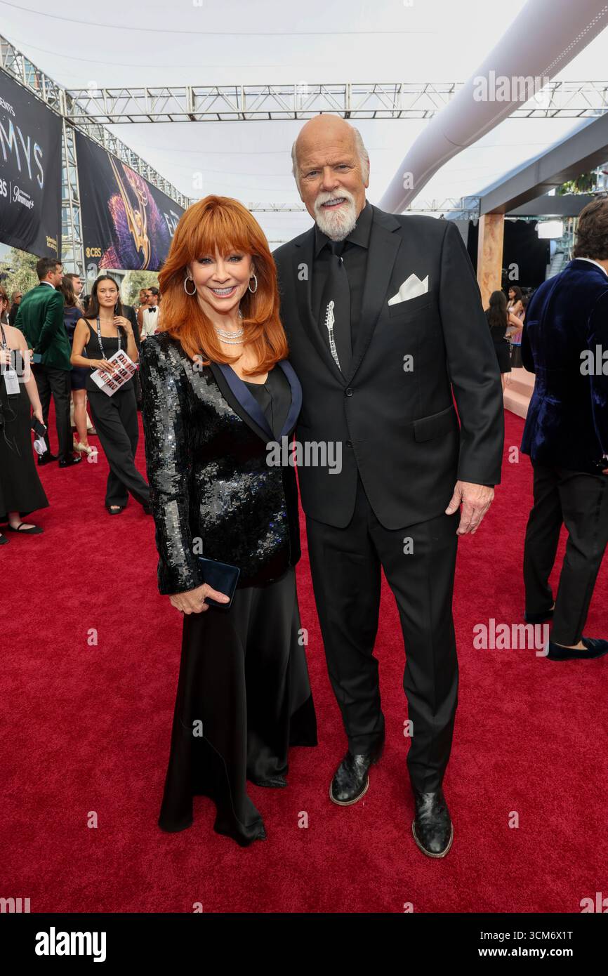 Reba McEntire and Rex Lynn walk the red carpet at the 77th Emmy Awards ...