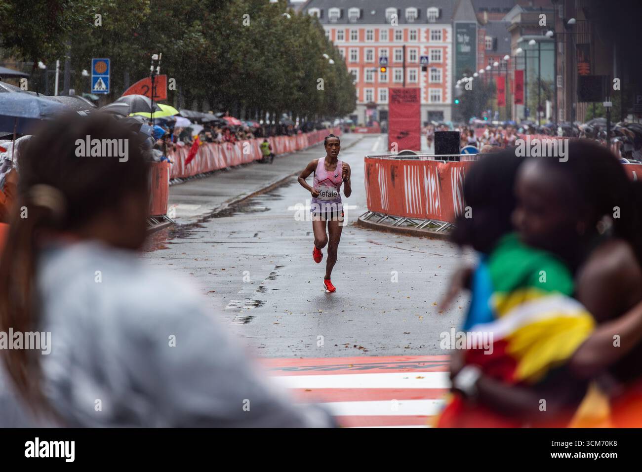 The third female athlete Wede Kefale of Ethiopia crosses the finishing ...