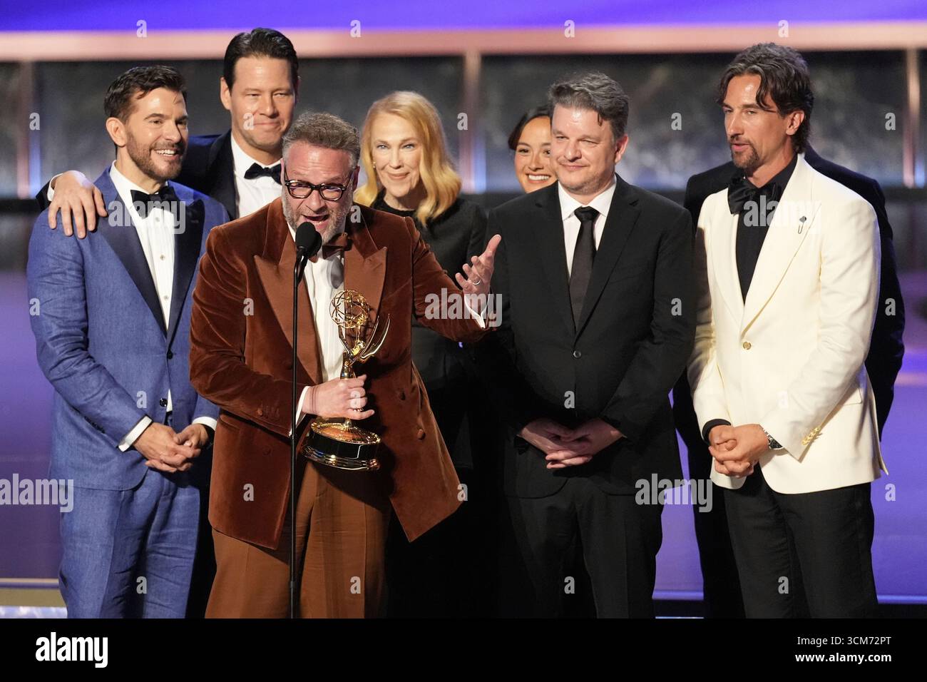 Seth Rogen, center, and the team from "The Studio" accept the award for ...