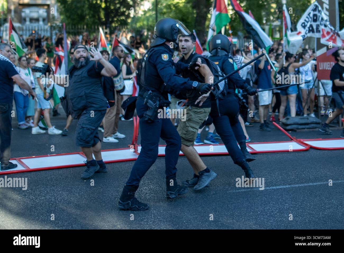 Spanish riot police charge at pro-Palestinian protesters during the ...