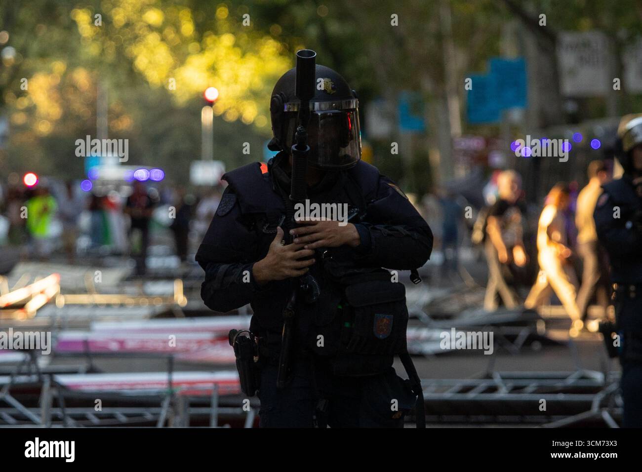 A riot police officer loads a rifle during the demonstration. While the ...