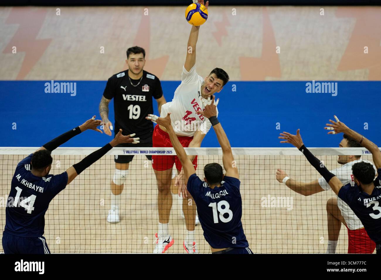 Gokçen Yuksel of Turkey spikes the ball against Libya during their pool ...