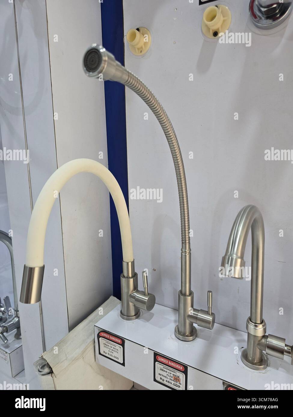 three types of kitchen water faucets on display in building materials ...