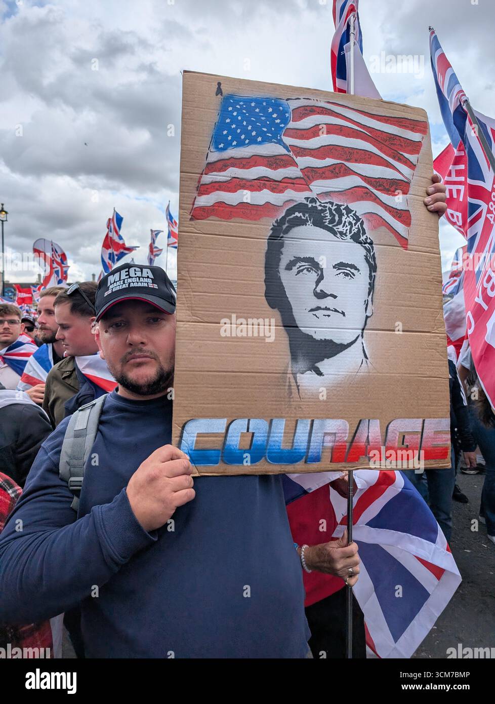 London, UK. 13th Sep, 2025. A man holds up a placard with a image of ...