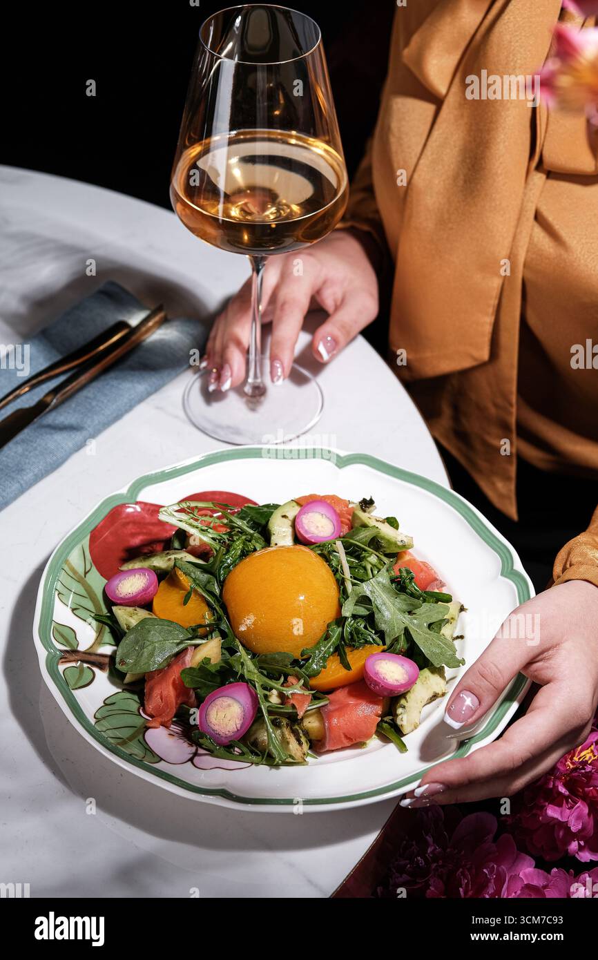 Enjoy an Elegant Salad Presentation with Wine in an Upscale Dining ...