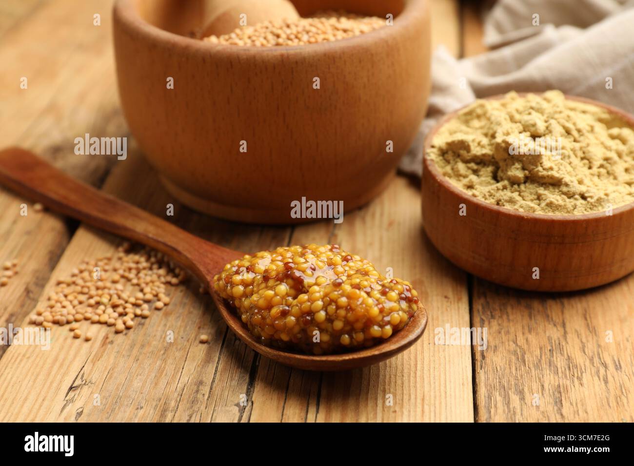 Different types of mustard on wooden table, closeup Stock Photo - Alamy