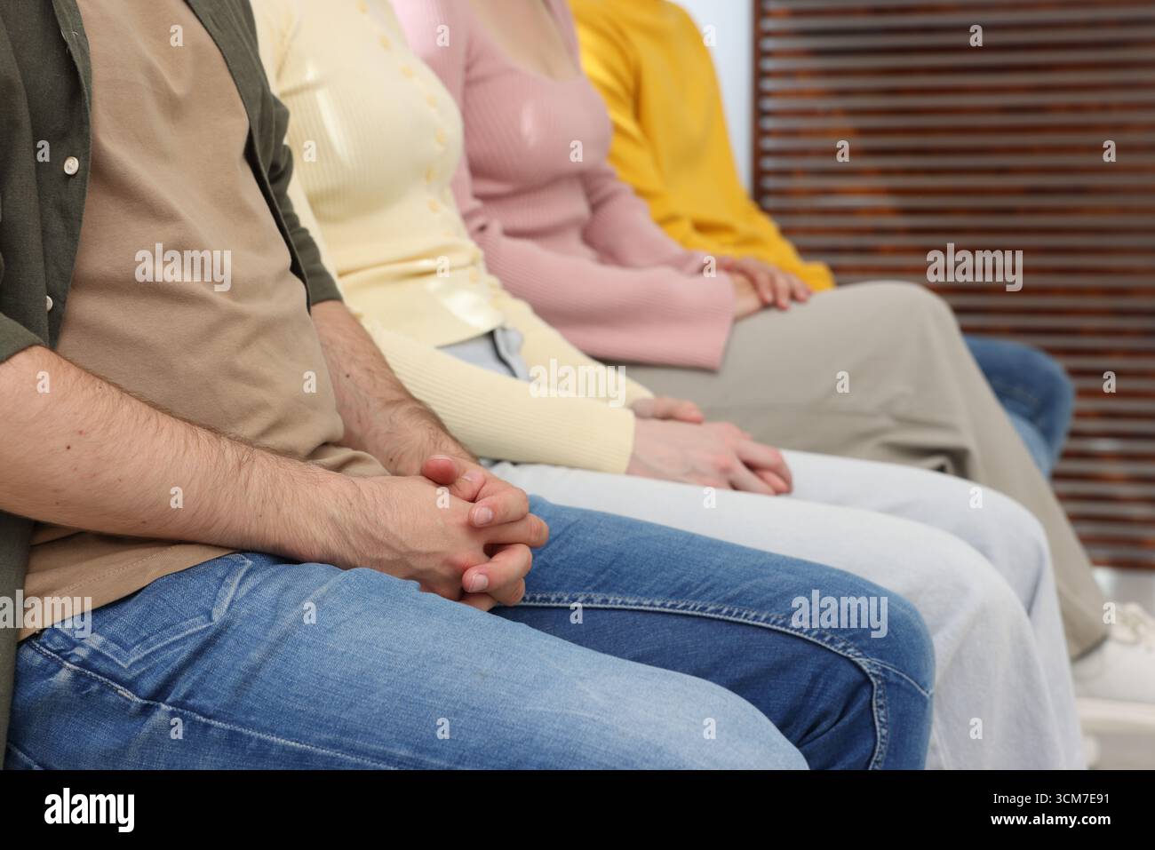 Group of people waiting in queue indoors, closeup Stock Photo - Alamy