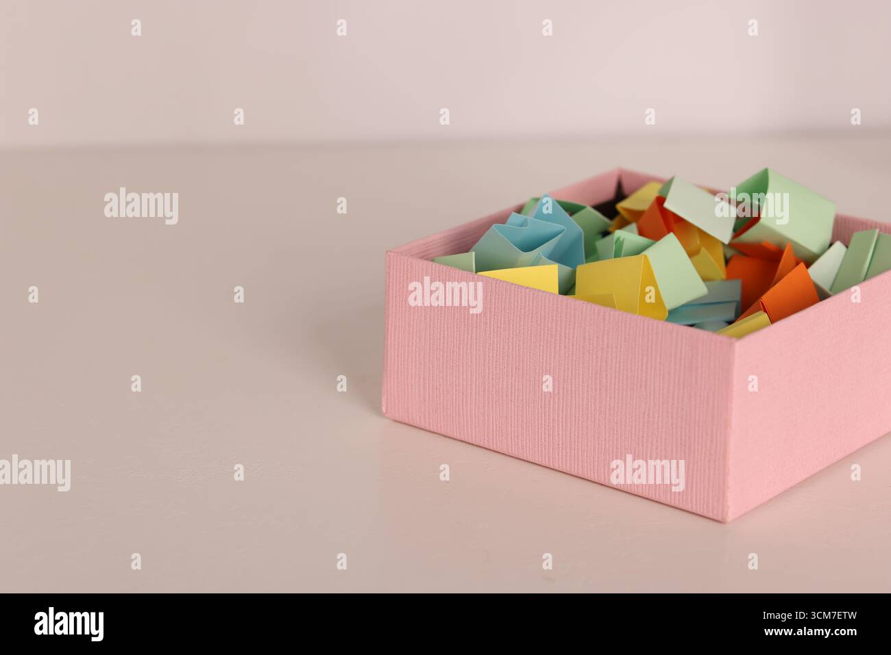 Color paper pieces in box on light table, closeup. Space for text Stock ...